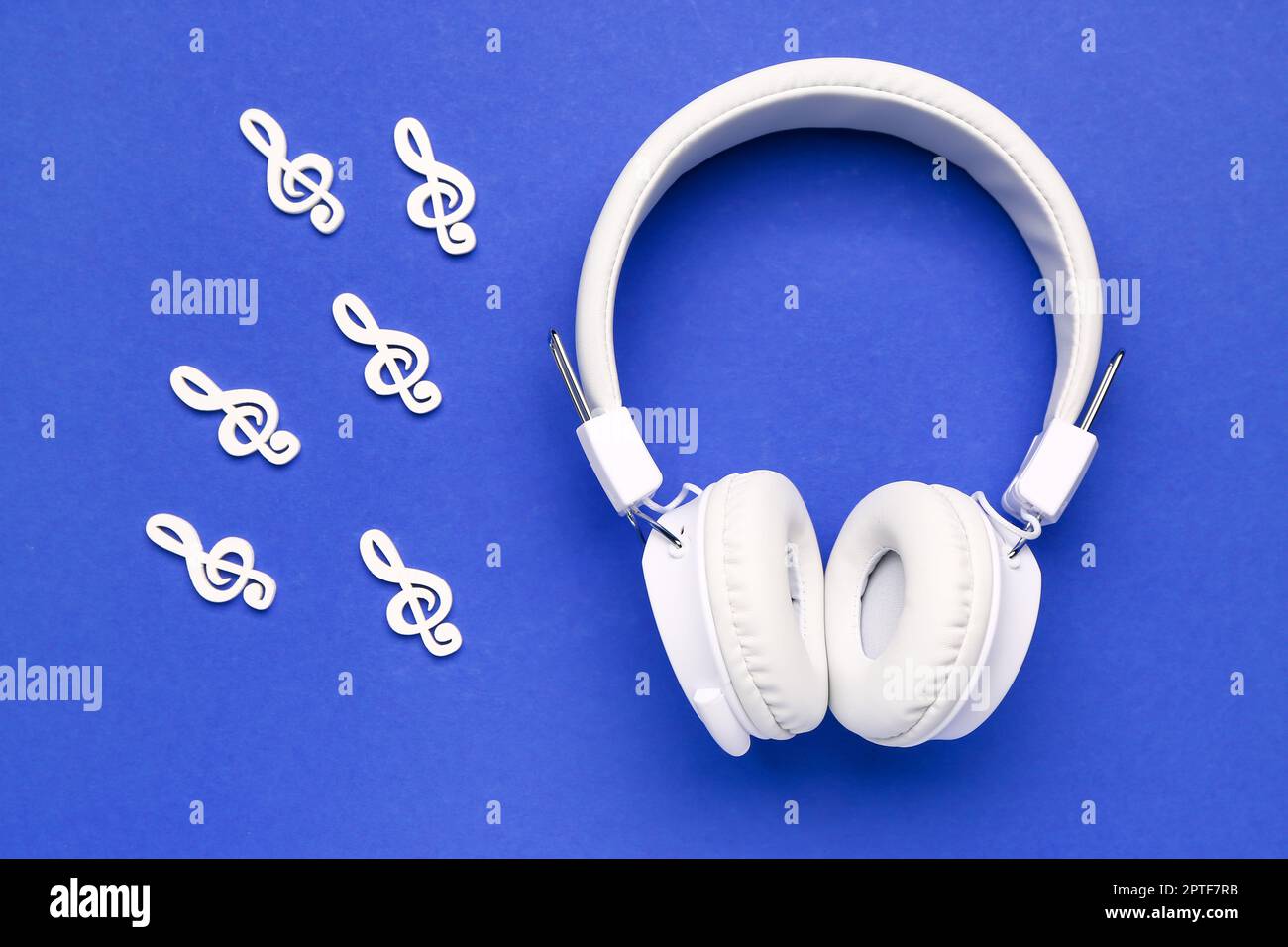 Modern white headphones and music notes on blue background Stock Photo ...