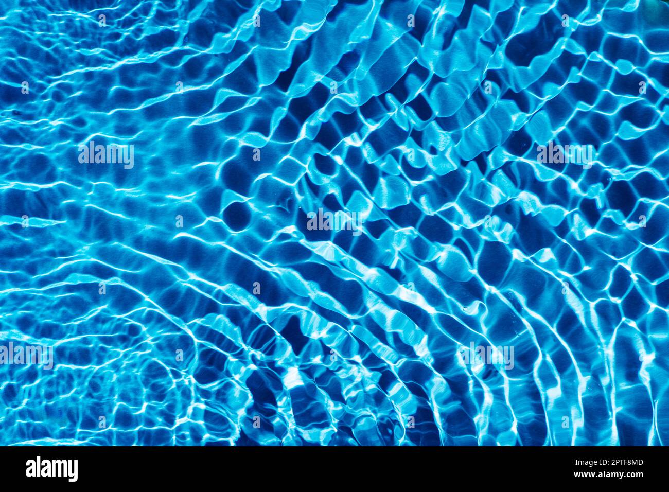 Rippled transparent fresh blue water gel surface in swimming pool with ...
