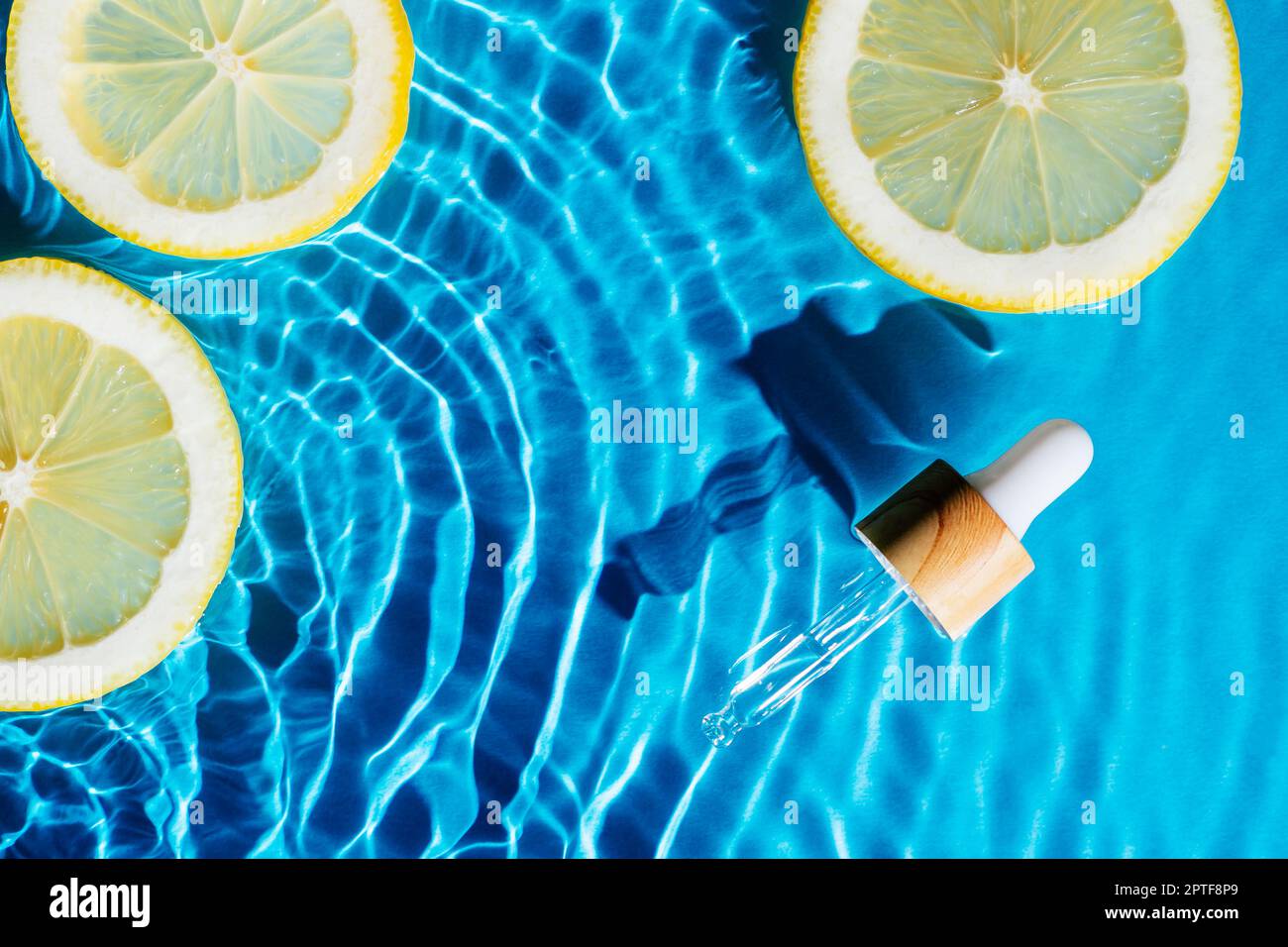 Facial pipette serum, whey beauty product near fruit citrus lemon in ...