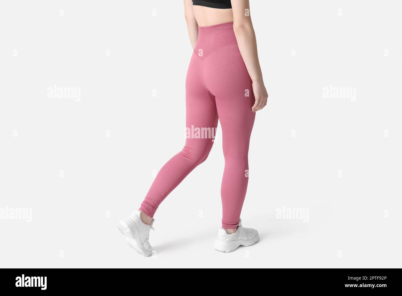 Sporty young woman in leggings on white background Stock Photo - Alamy