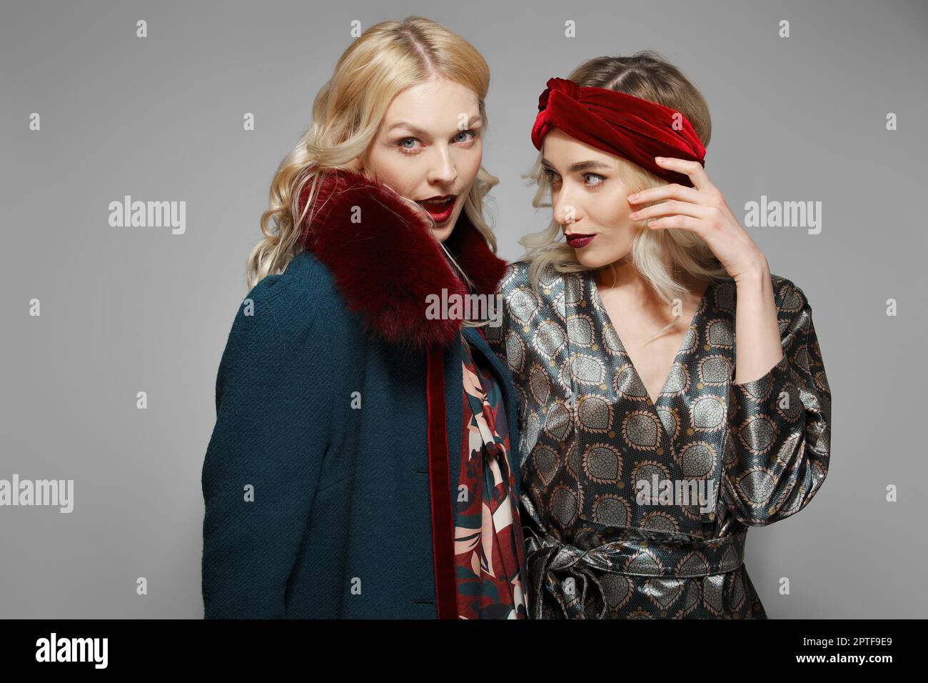Two fashion models expressing amazement and disbelief. Doubtful people ...