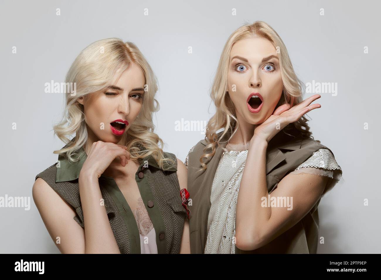 Two tricky and surprised blonde girls Stock Photo - Alamy