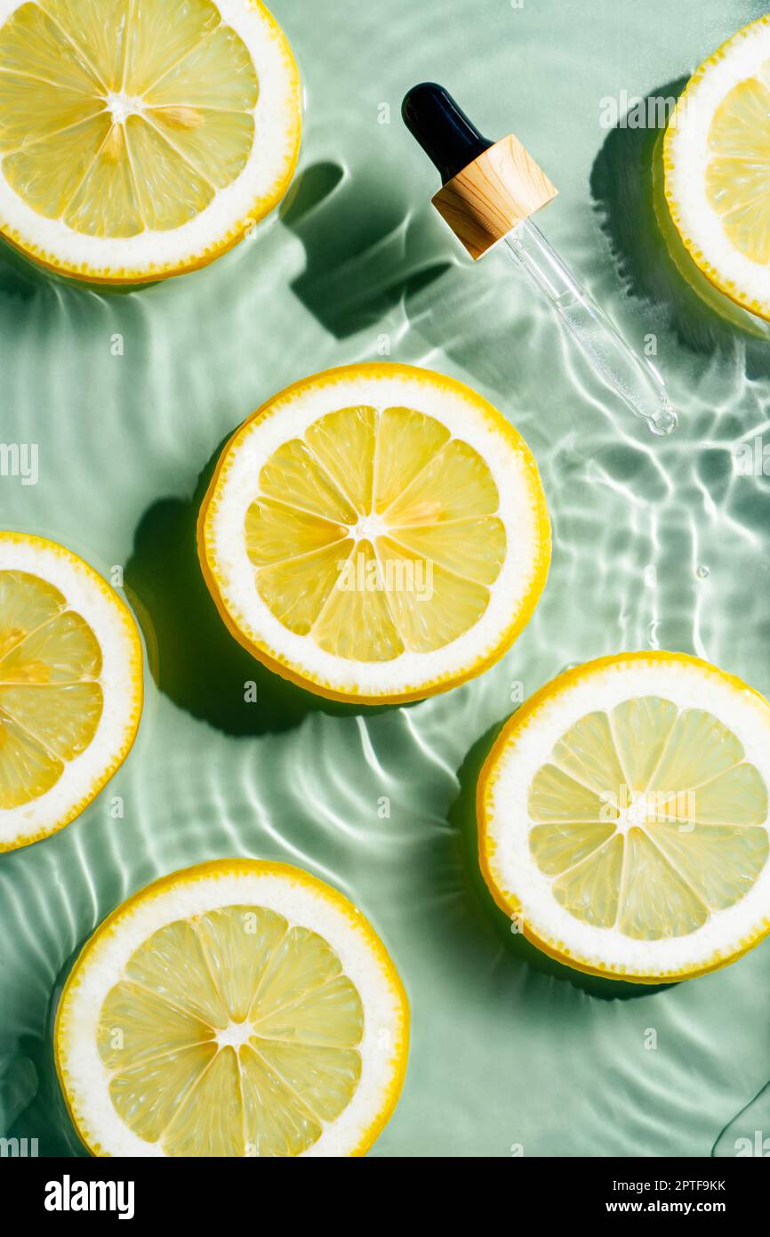 Facial pipette serum, whey beauty product near fruit citrus lemon in ...
