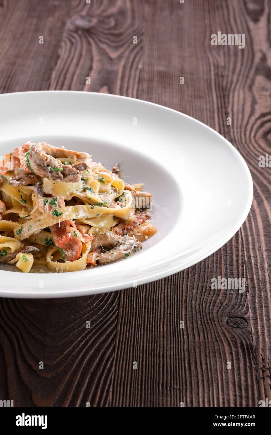 Pasta with bacon and squid Stock Photo - Alamy