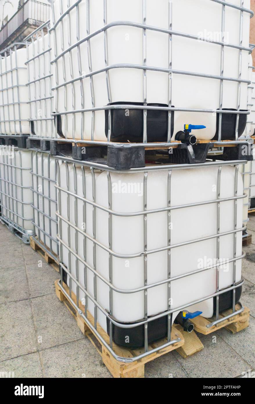Lots of cube water tanks. 1000 litres containers piled outdoors Stock ...