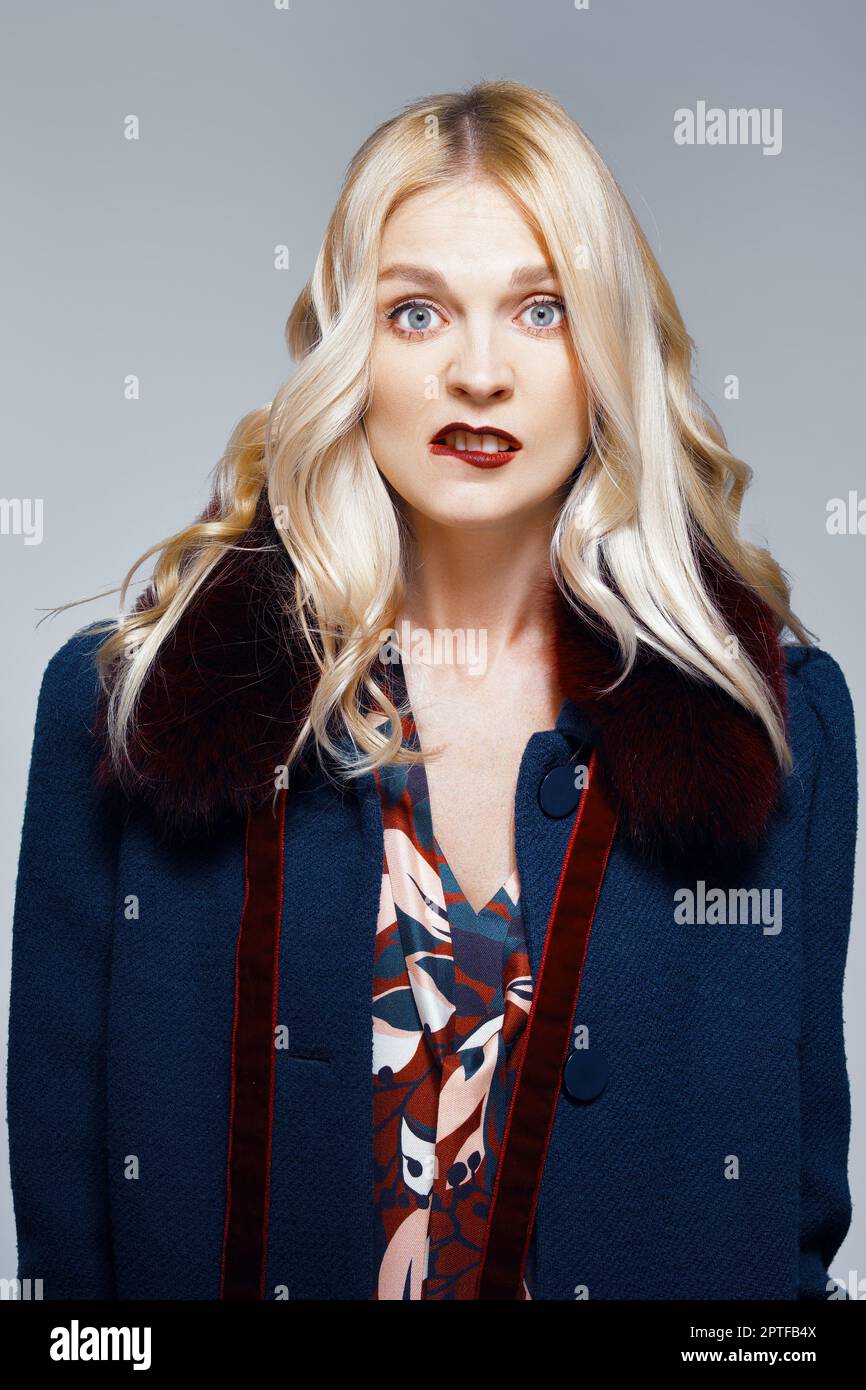 Pretty discouraged girl biting lip, uncertain mood. Portrait of lady in ...