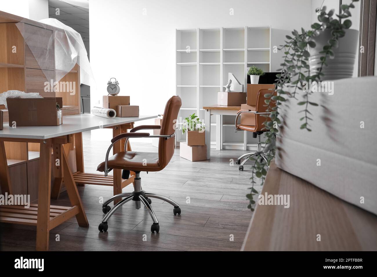 Workplaces with cardboard boxes in office on moving day Stock Photo - Alamy