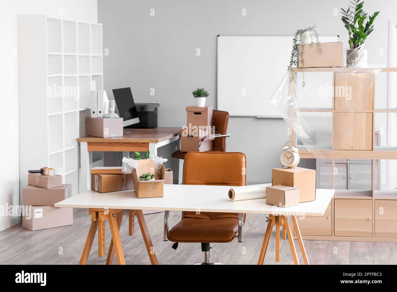 Workplace with cardboard boxes in office on moving day Stock Photo - Alamy