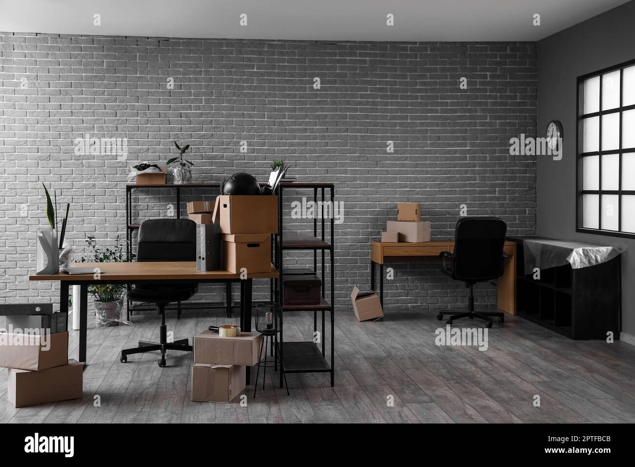 Workplaces with cardboard boxes in office on moving day Stock Photo - Alamy