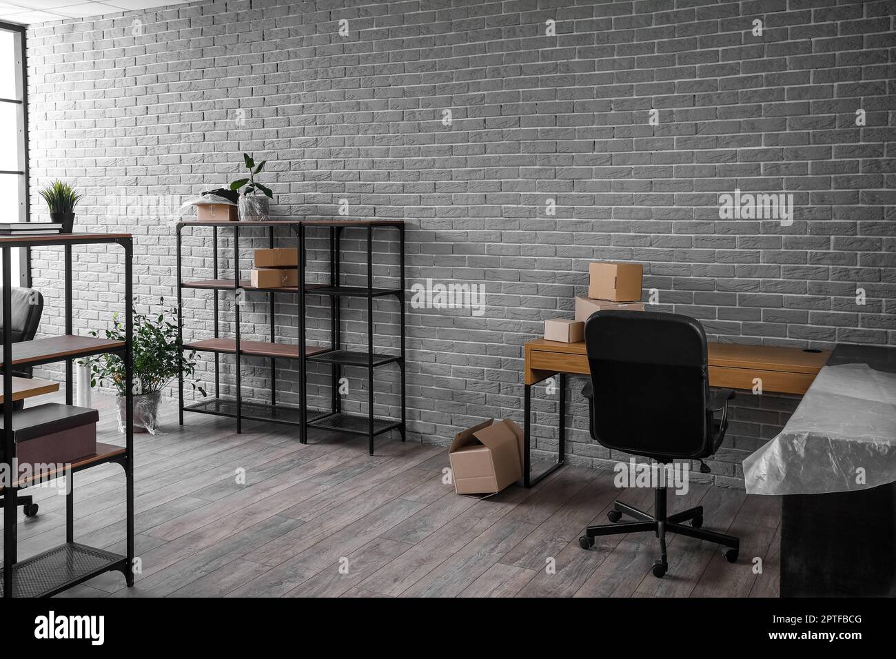 Workplace with cardboard boxes in office on moving day Stock Photo - Alamy