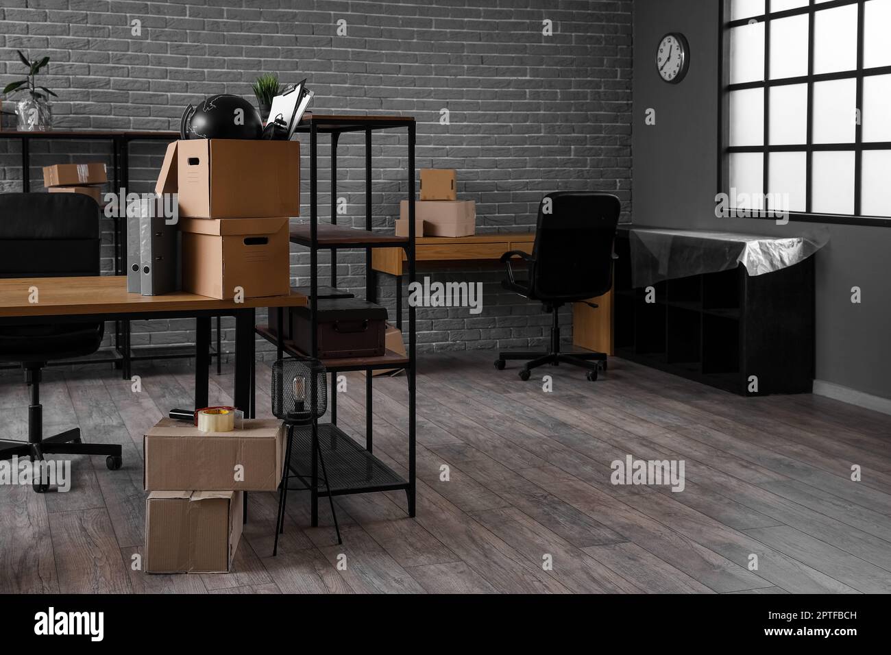 Workplaces with cardboard boxes in office on moving day Stock Photo - Alamy