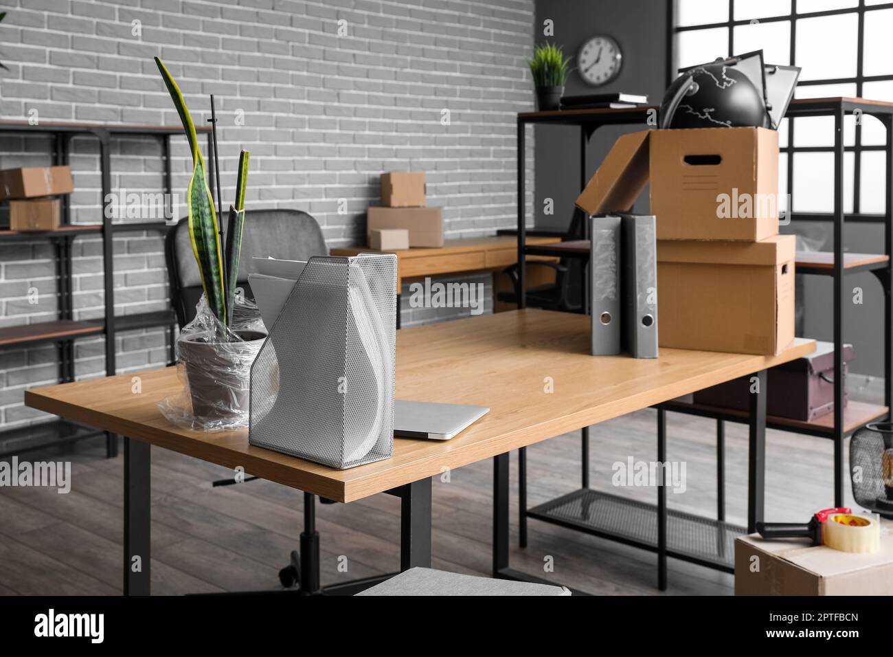 Workplace with cardboard boxes in office on moving day Stock Photo - Alamy