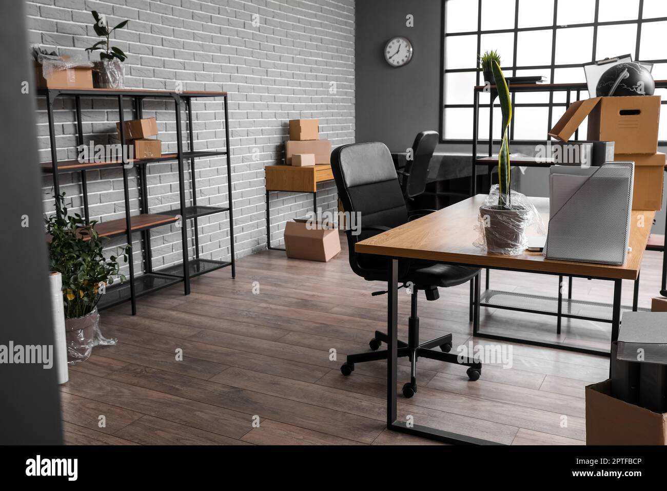 Workplaces with cardboard boxes in office on moving day Stock Photo - Alamy