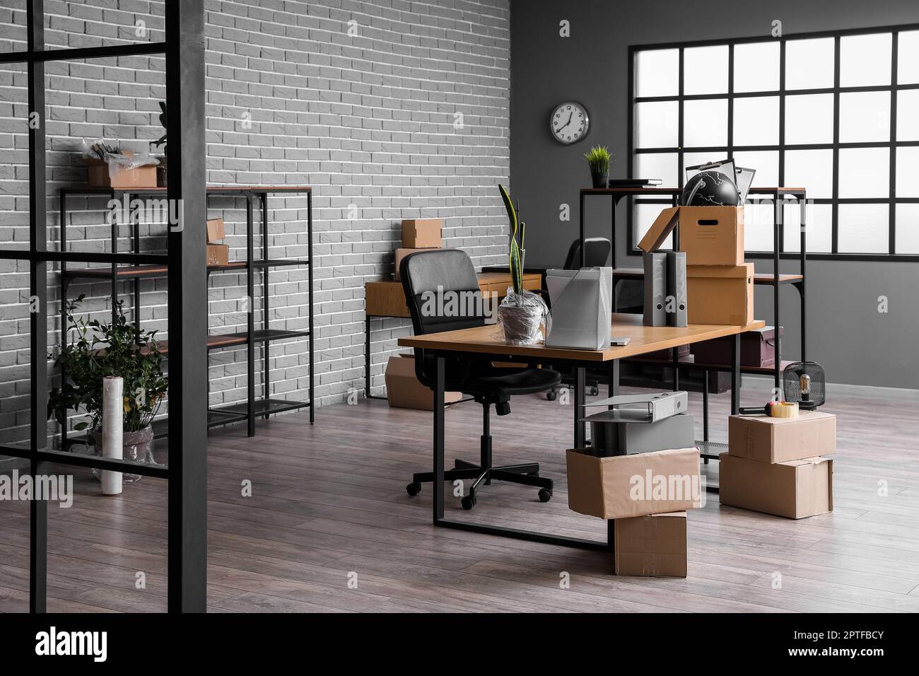 Workplace with cardboard boxes in office on moving day Stock Photo - Alamy