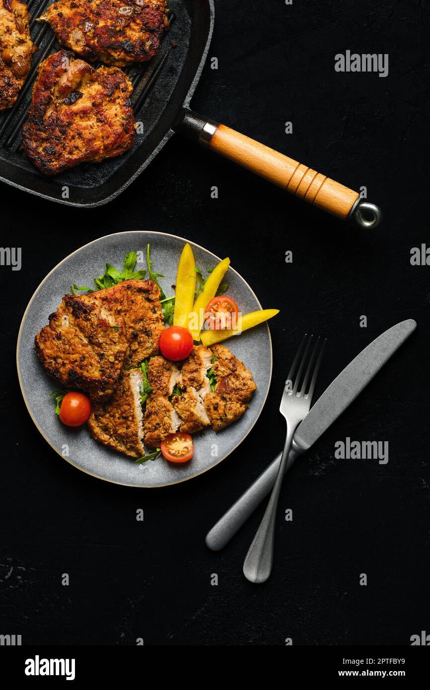 Pork chop fillet baked in oven with seasoning and herbs Stock Photo - Alamy