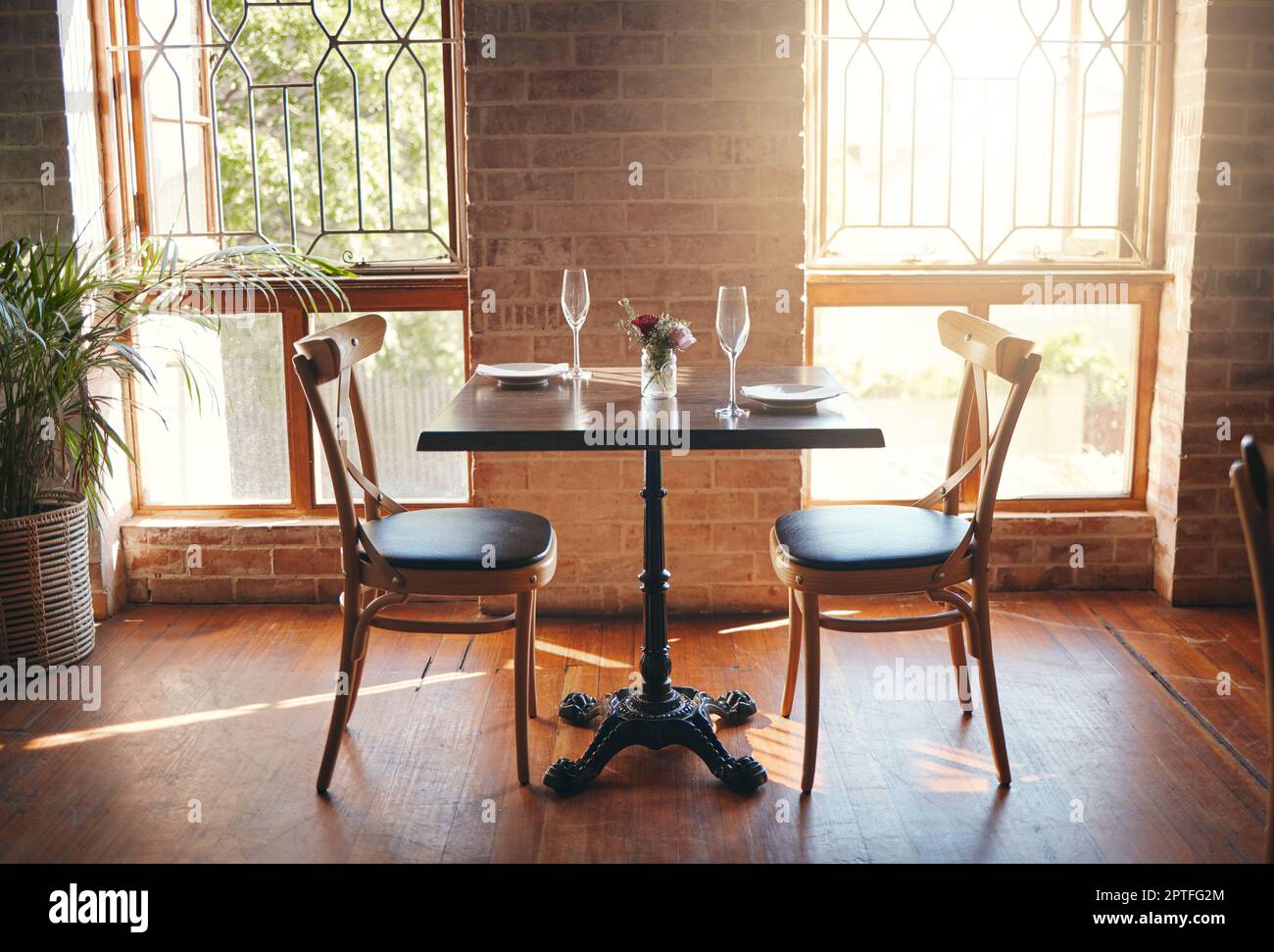Empty room, glasses and table at a restaurant for a romantic date ...