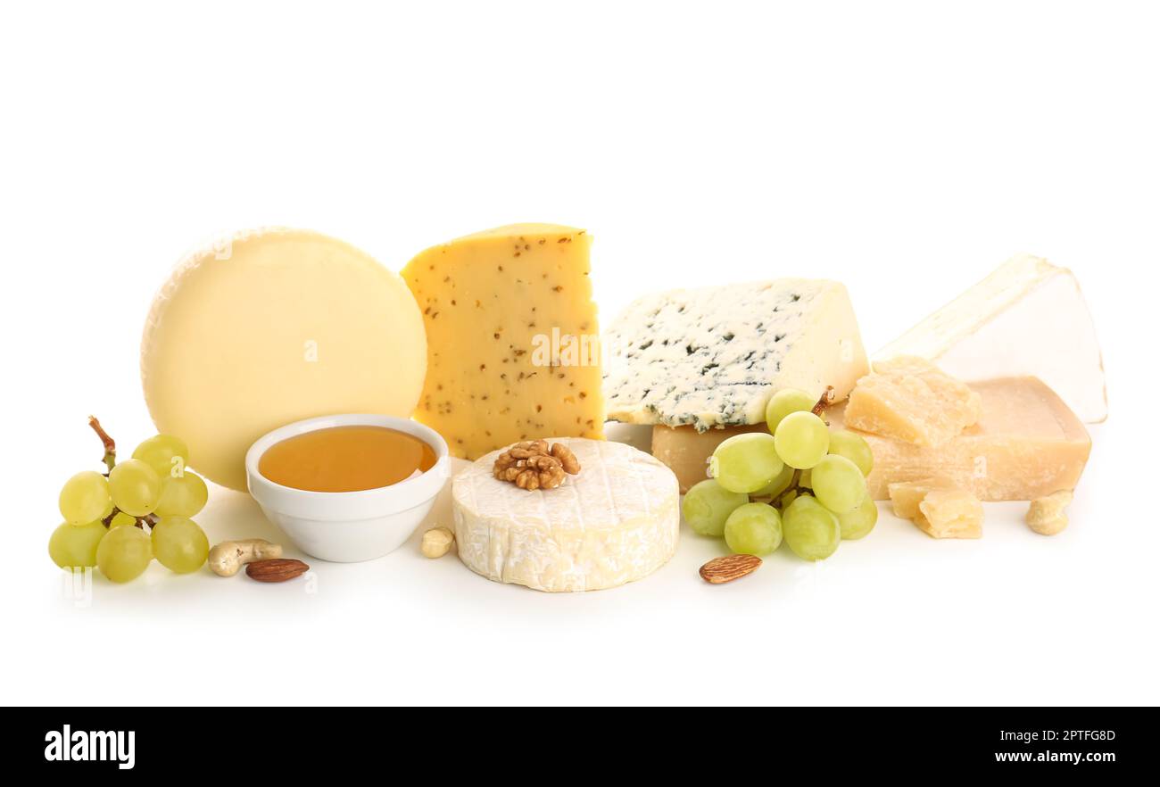 Different types of cheese with honey, nuts and grapes isolated on white ...