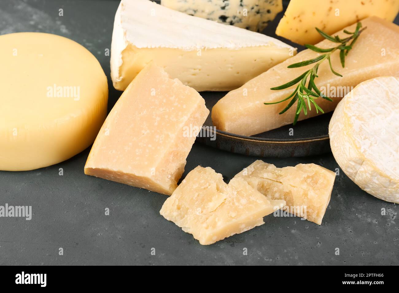 Different types of cheese on green background Stock Photo - Alamy