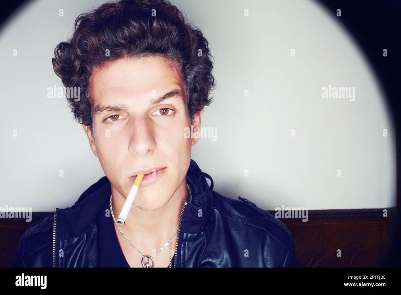 I do what I like....Portrait of a cool dude smoking a cigarette with ...