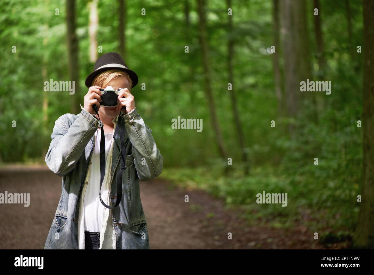 Creativity in nature. Closeup portrait of a young man taking pictures ...