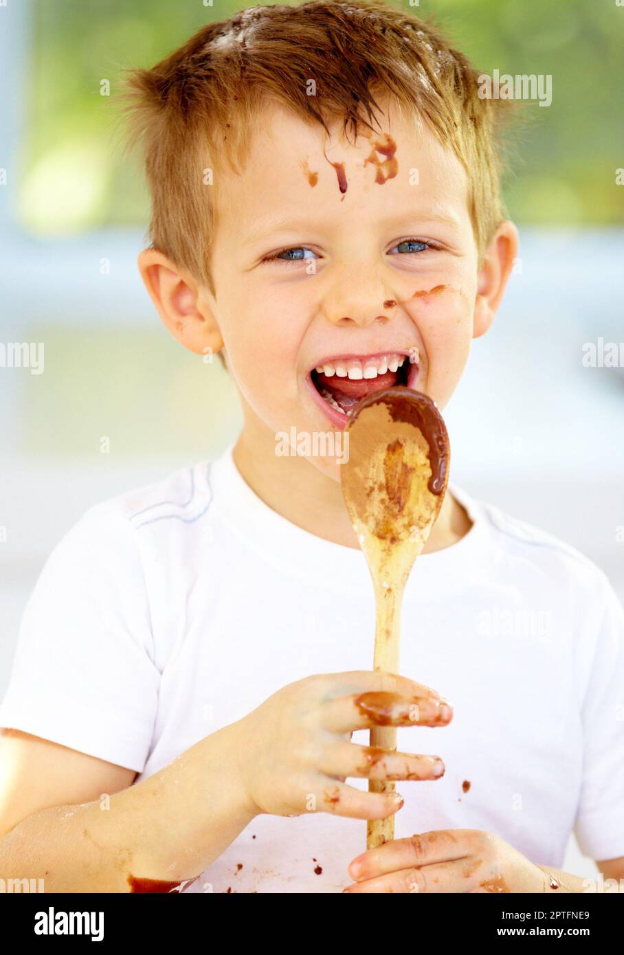 The future of the culinary arts. A little boy covered in dough and ...