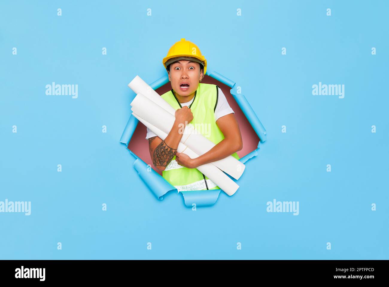 Young fearful man posing isolated over blue backdrop wearing yellow ...