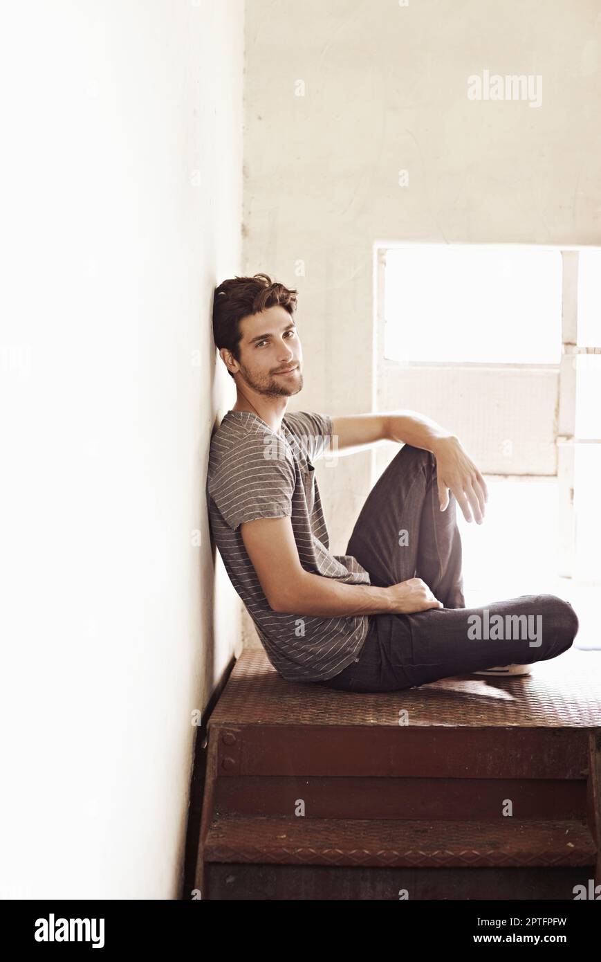 Just a chilled Sunday. Young guy sitting and contemplating his future ...