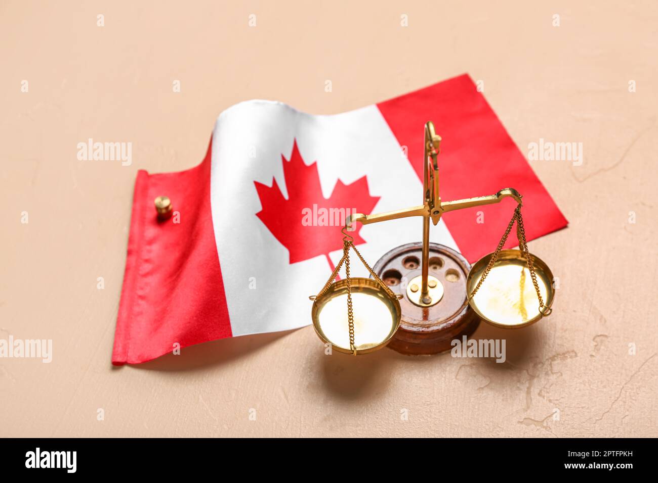 Flag of Canada with justice scales on beige background Stock Photo - Alamy