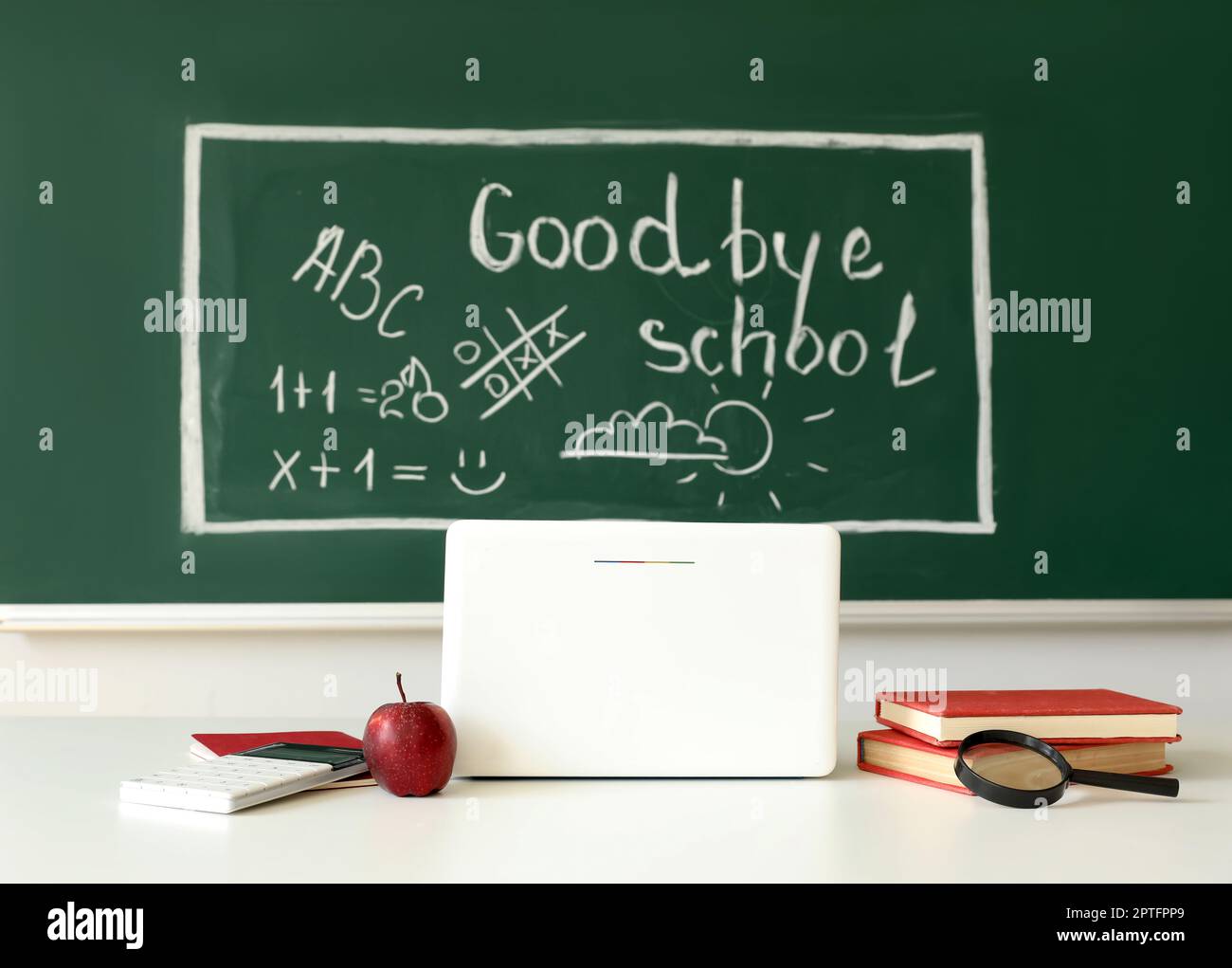 Blackboard with text GOODBYE SCHOOL, drawings and teacher's table in ...