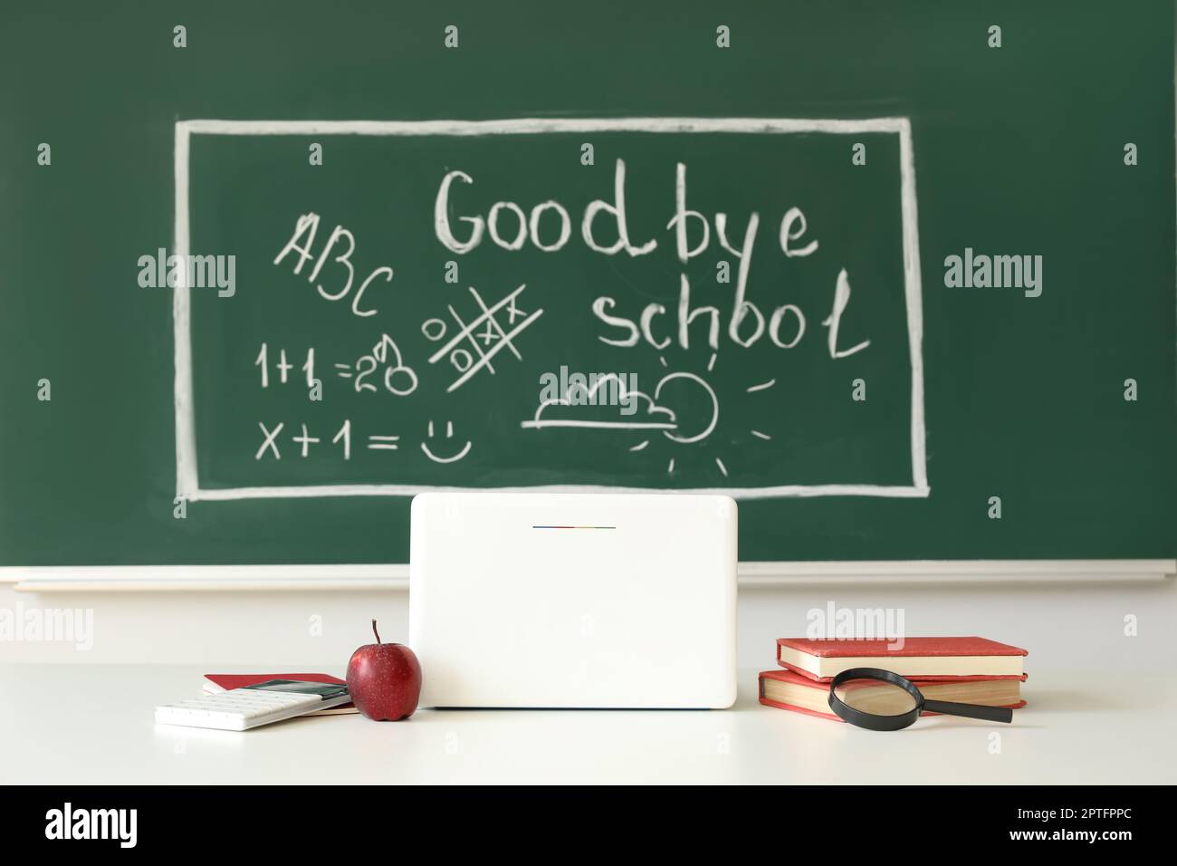Blackboard with text GOODBYE SCHOOL, drawings and teacher's table in ...