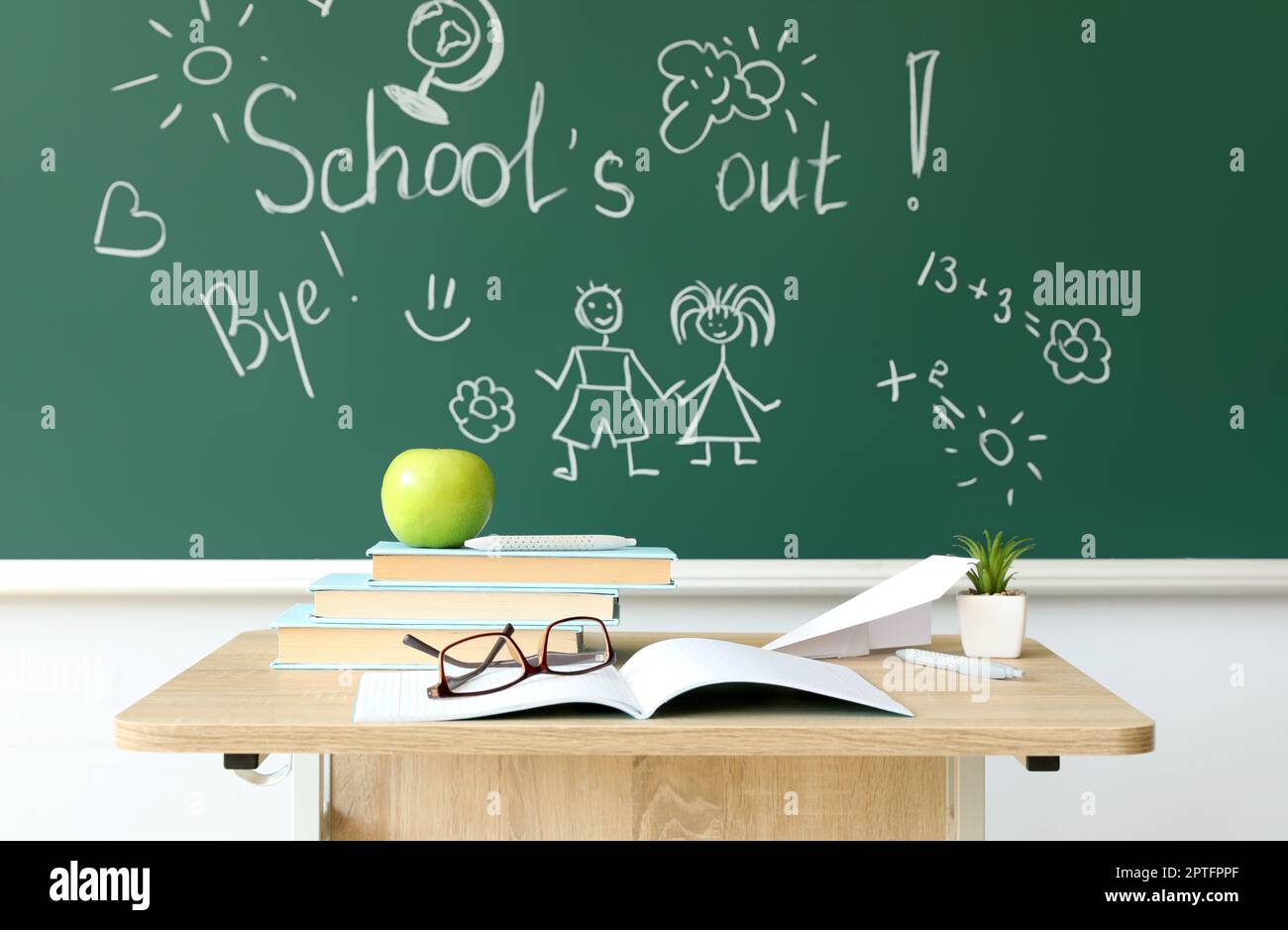 Text SCHOOL'S OUT with drawings on blackboard in classroom Stock Photo ...