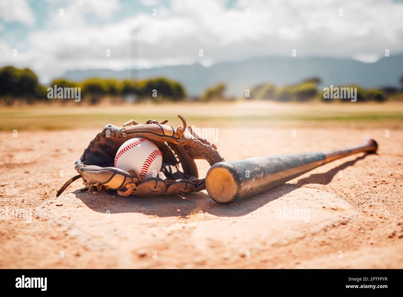 Baseball, sport and empty with a bat, ball and mitt on a base plate on ...