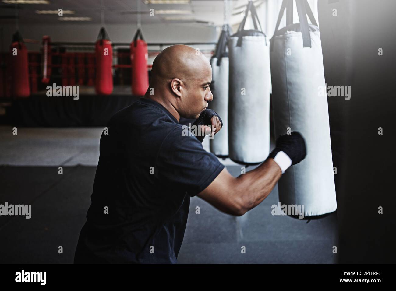 Learn how to fight alone. a kick-boxer training in a gym Stock Photo ...