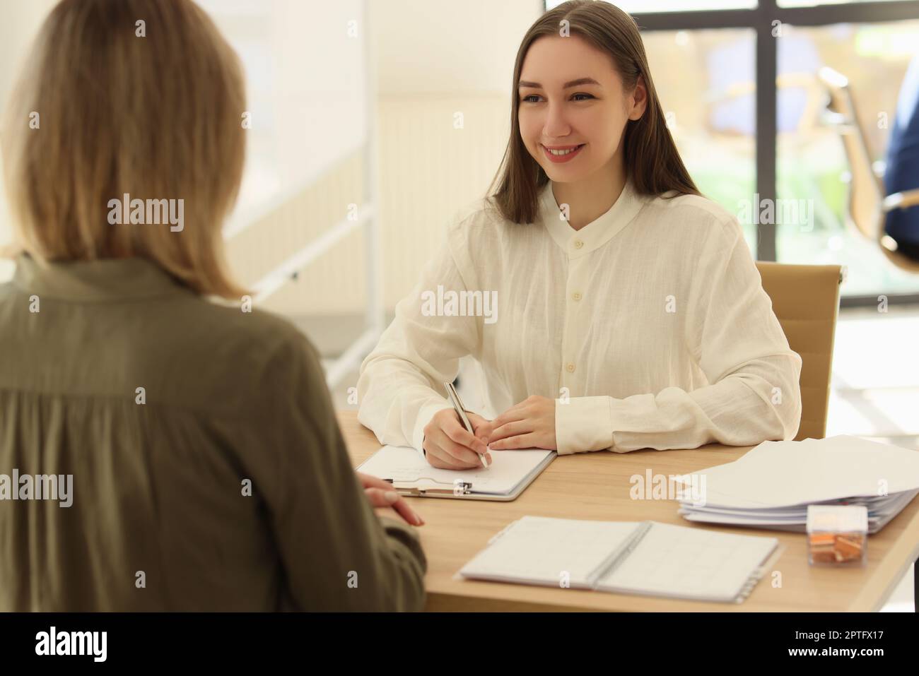 Positive manager conducts job interview with woman in office Stock ...