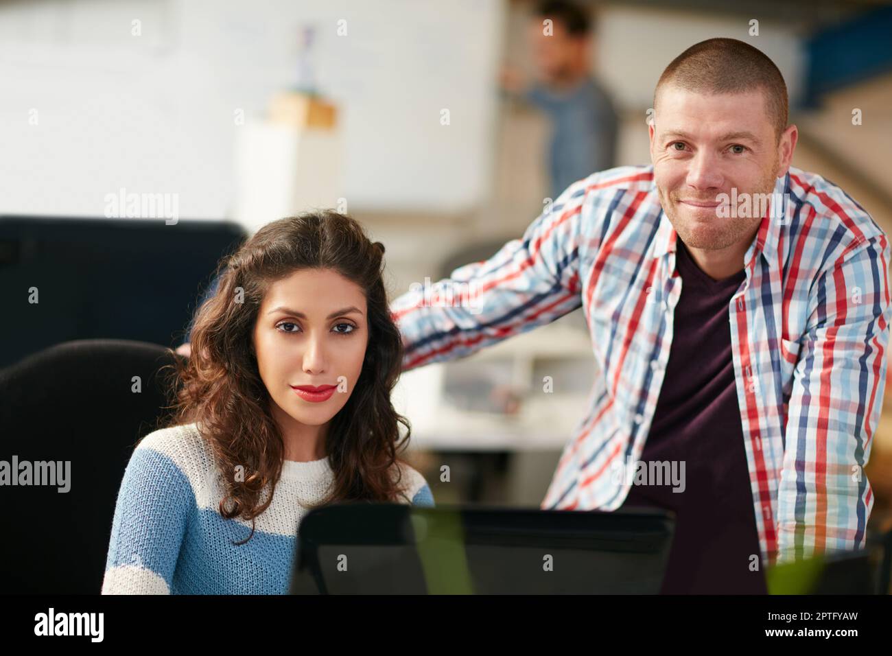Two minds to create a winning design. two coworkers using a computer ...