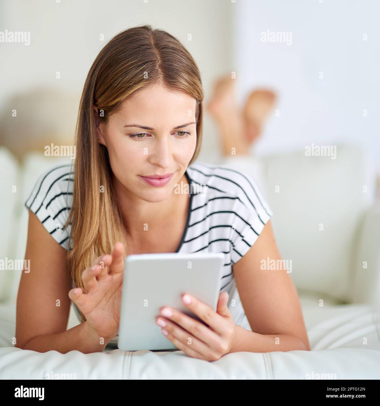What to search for now...a young woman browsing the internet at home ...