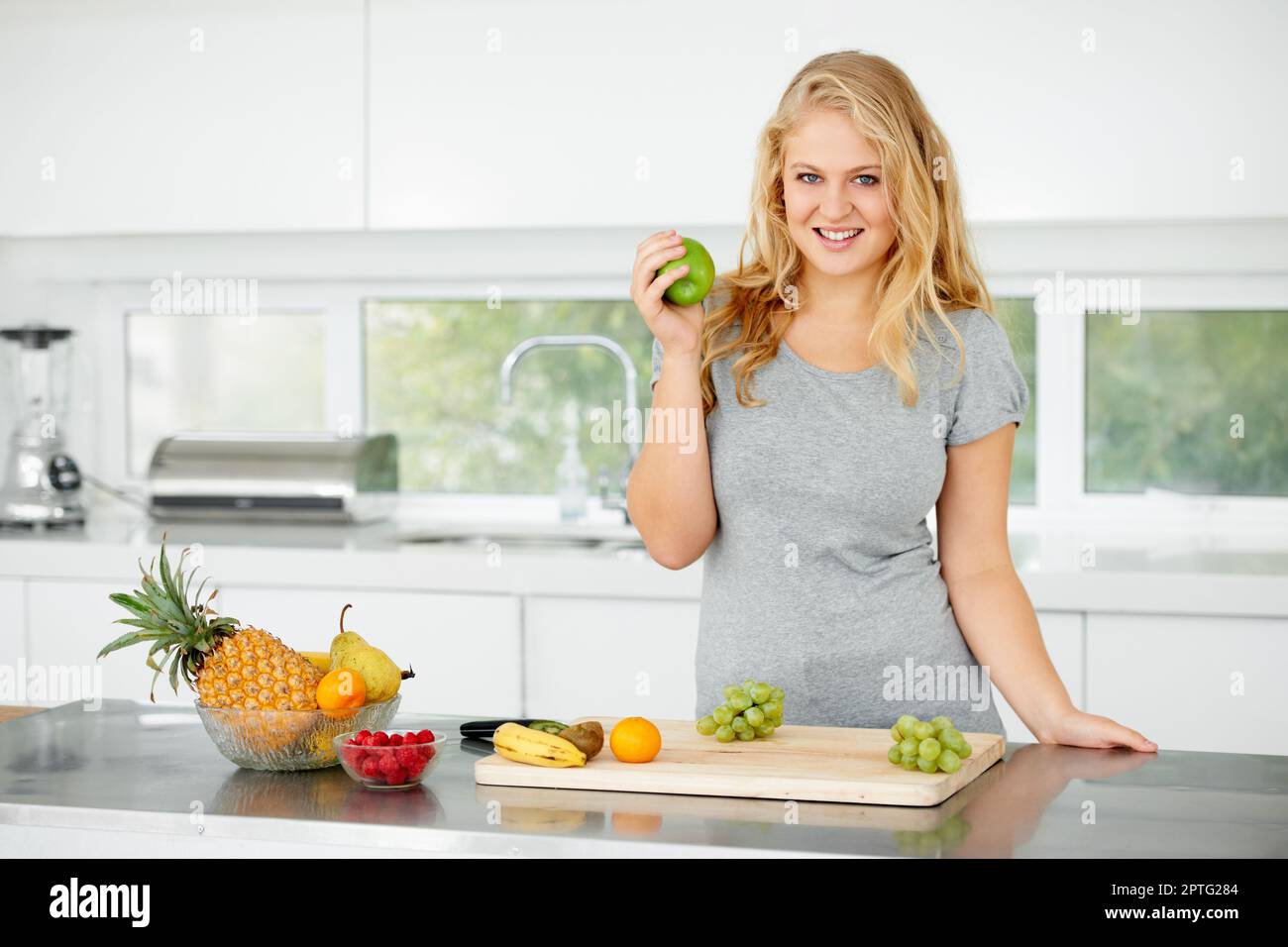 Keeping it healthy. Curvy and beautiful young woman holding an apple ...