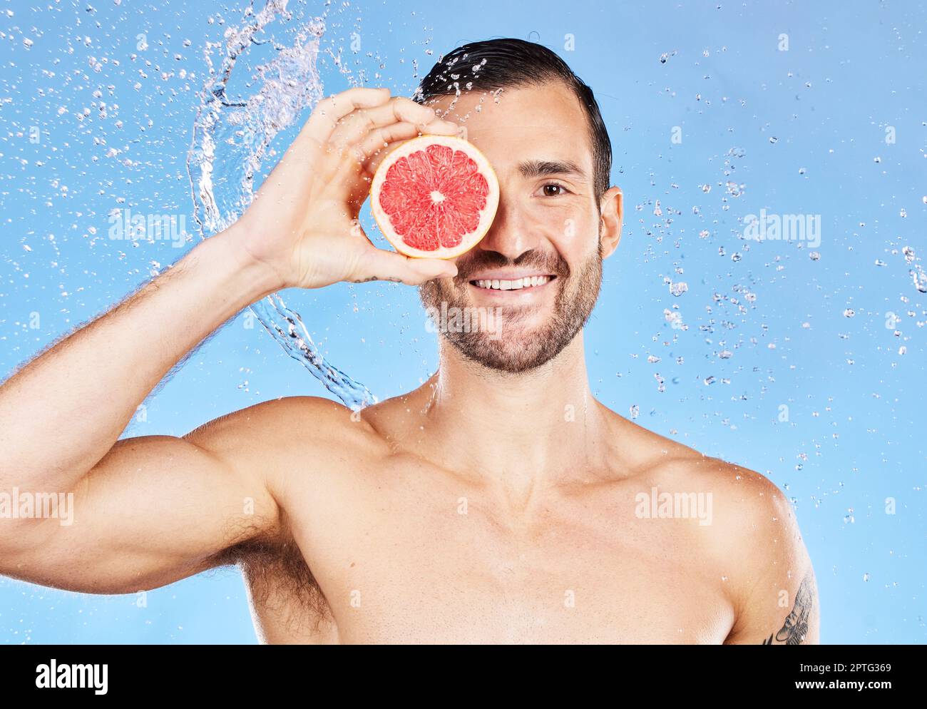 Portrait, water splash and skincare with a handsome young male posing for natural body care ...