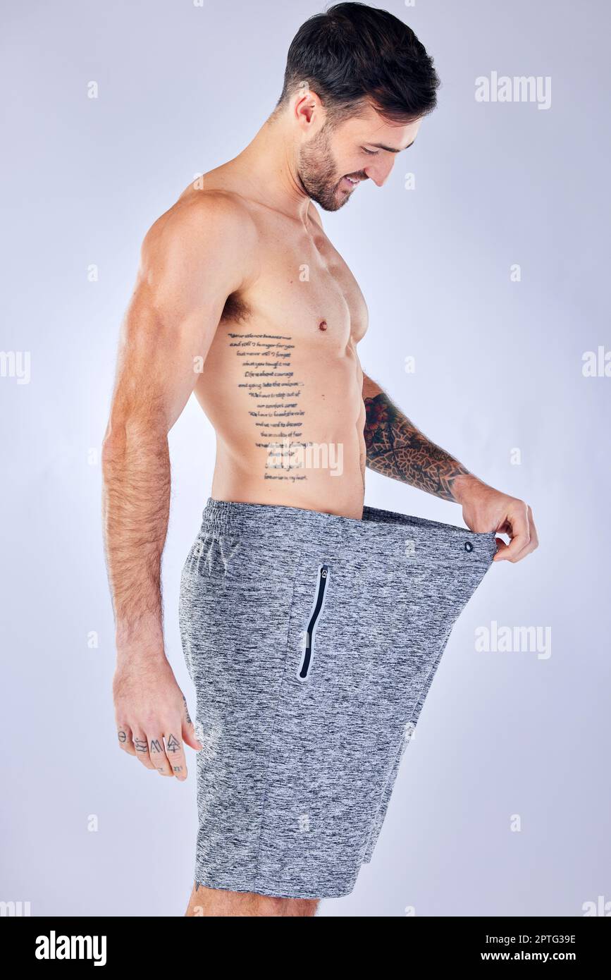 Motivation, diet and weight loss, man checking pants size change from ...