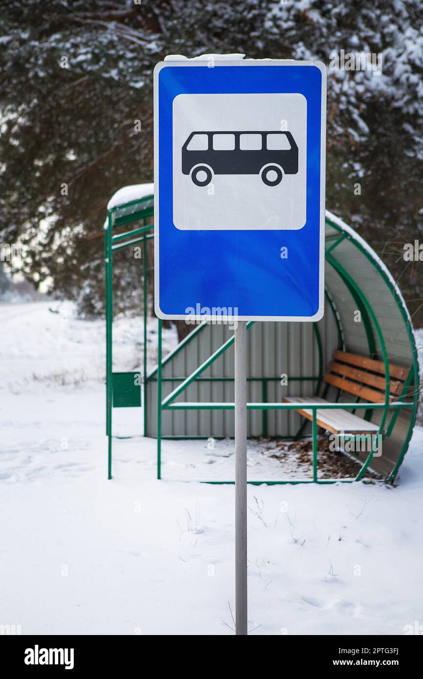 Bus stop in the middle of a beautiful winter road in the middle of the ...