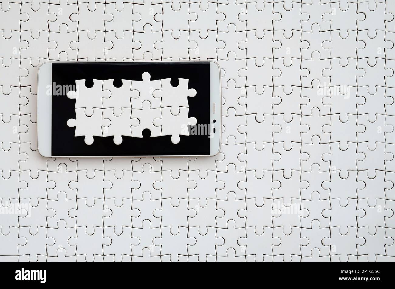 A modern big smartphone with several puzzle elements on the touch ...