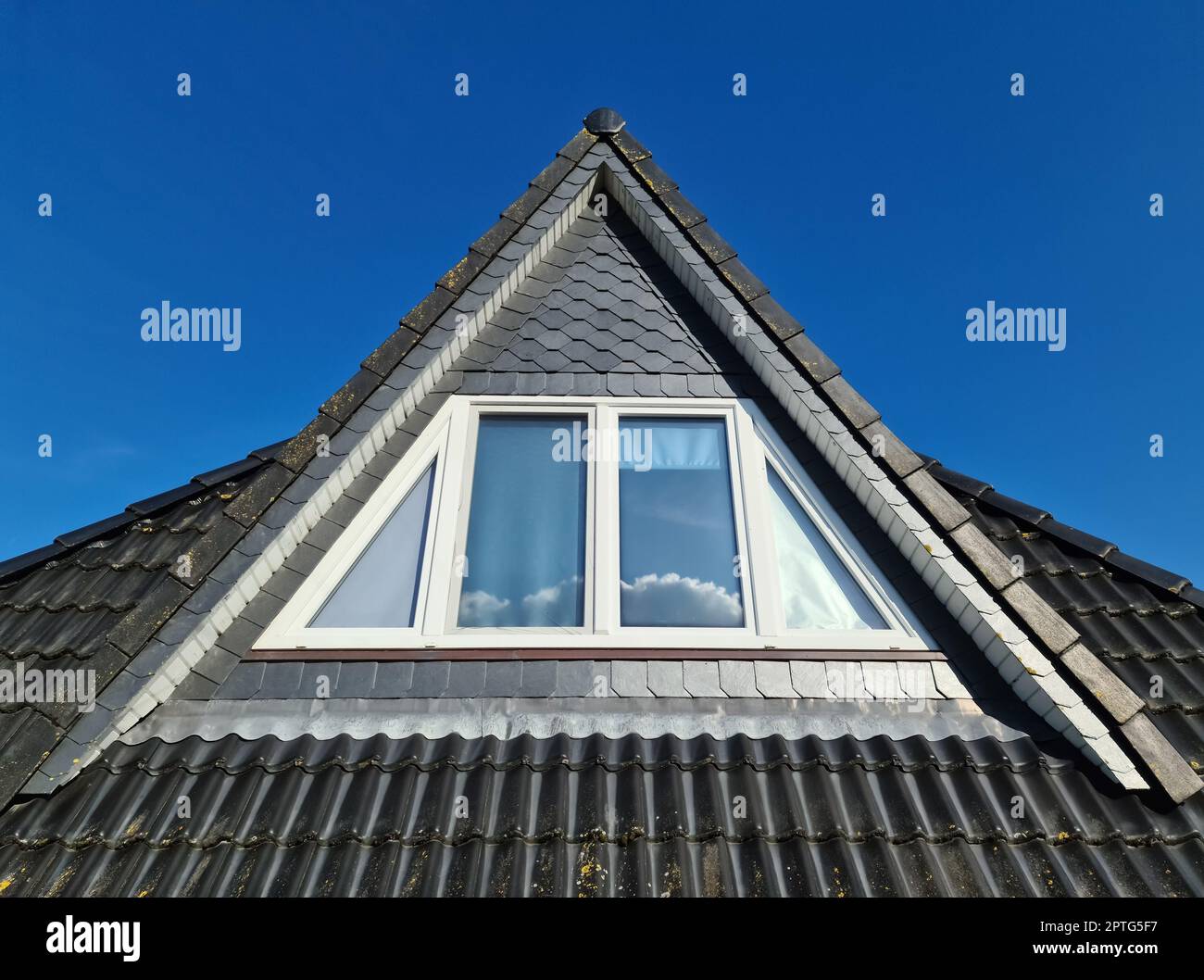 Roof window in velux style with black roof tiles Stock Photo - Alamy