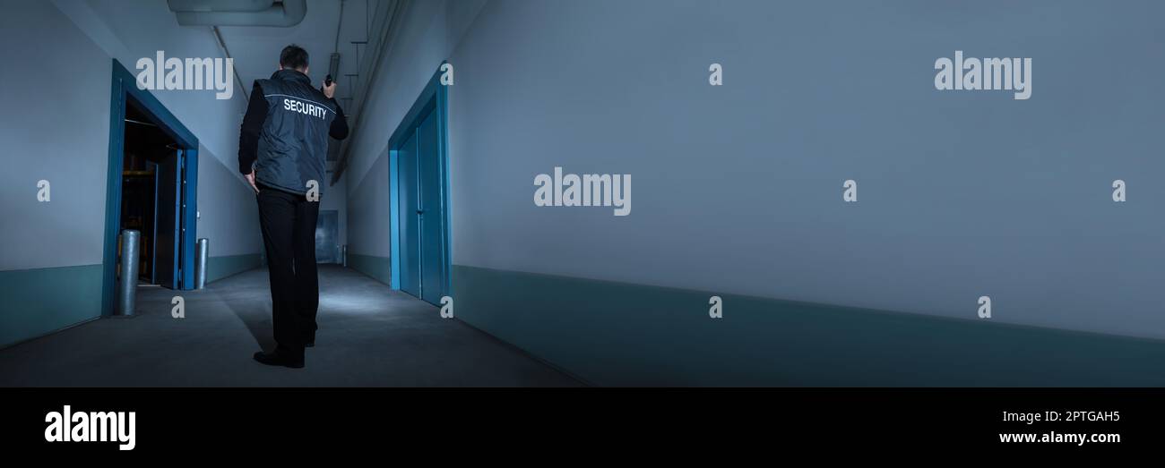Security Guard With Flashlight At Night In Warehouse Stock Photo - Alamy