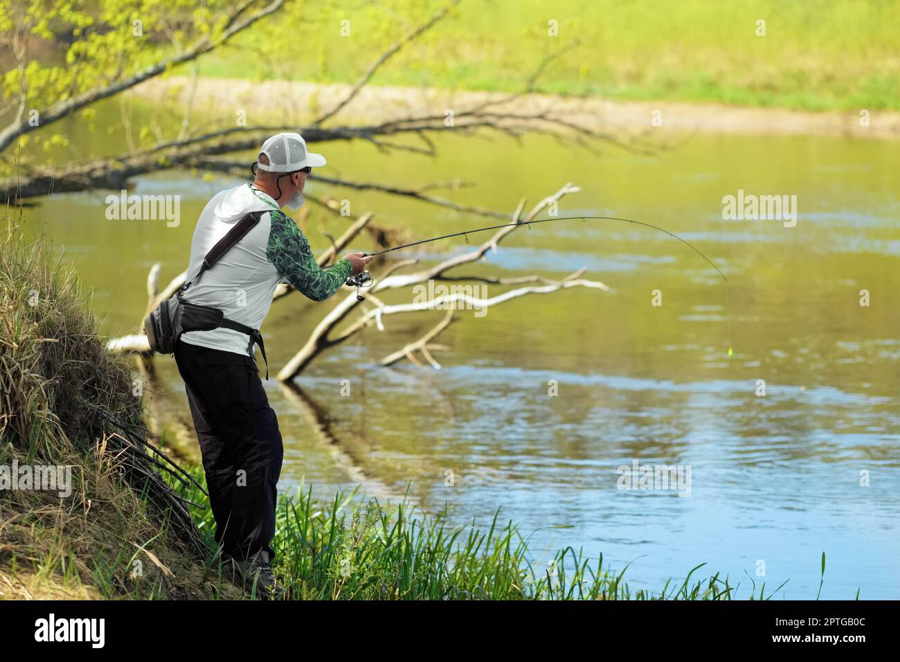 Fisherman trying to do a perfect cast, throwing lure. Spining fishing ...