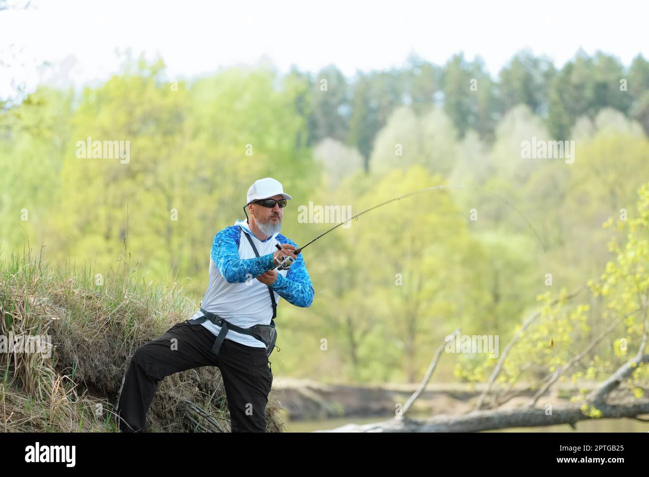 Fisherman trying to do a perfect cast, throwing lure. Spining fishing ...