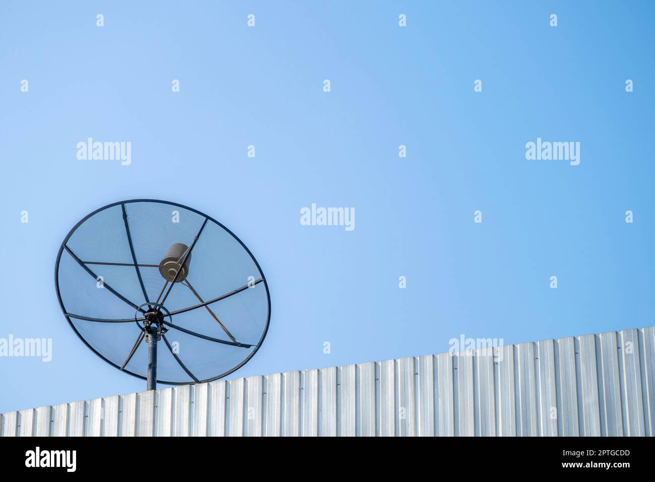 Old satellite dish on the blue sky background Stock Photo - Alamy