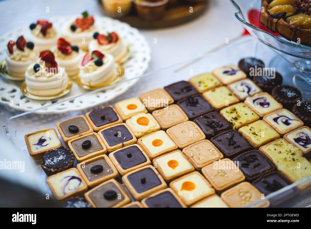 Delicious wedding reception candy bar dessert table with various sweets ...