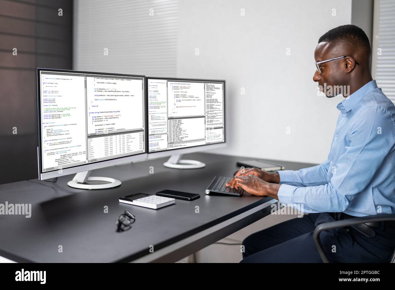 African American Coder Using Computer At Desk. Web Developer Stock ...