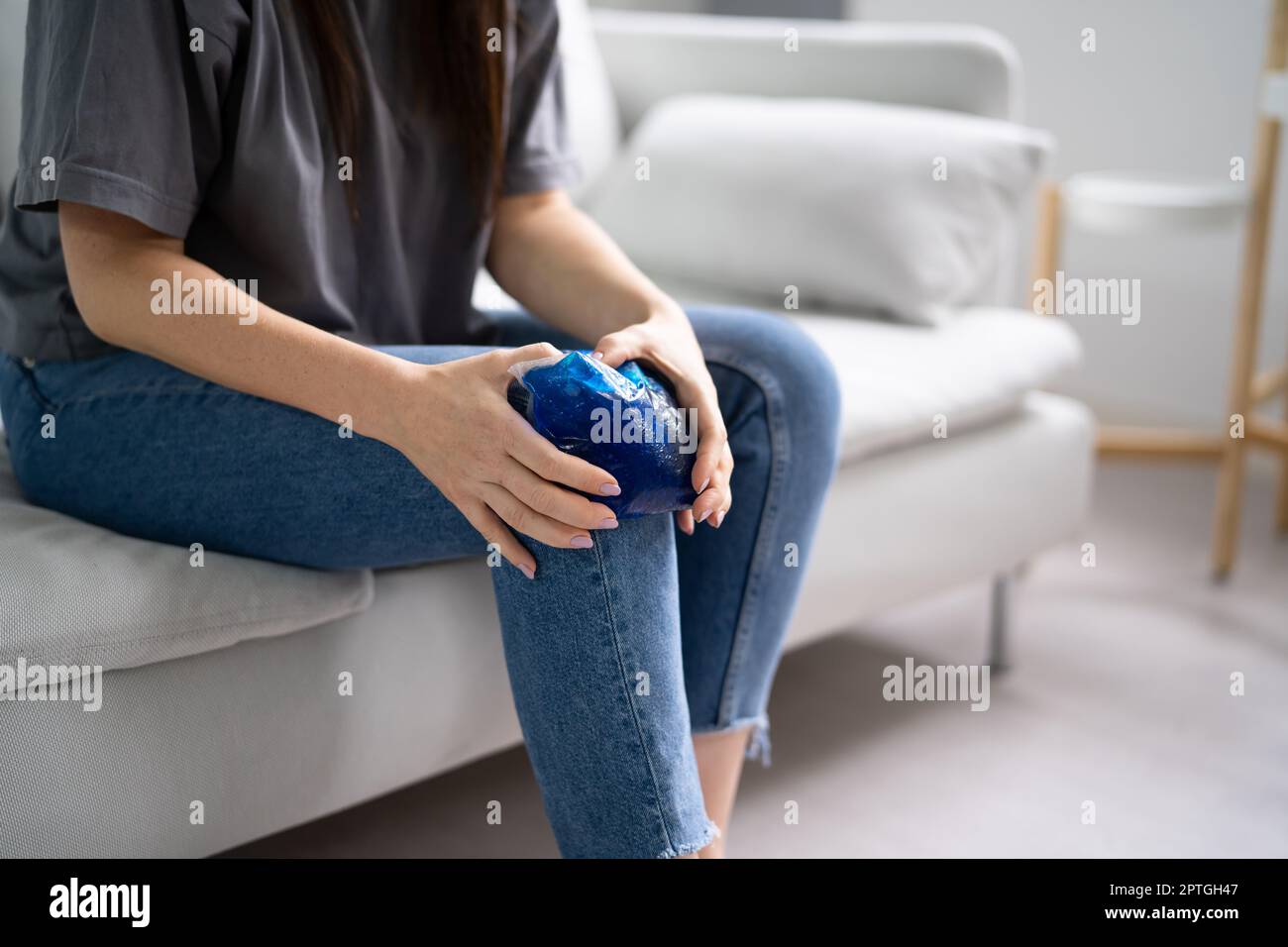 Applying Ice Pack To Knee Joint After Injury Stock Photo - Alamy