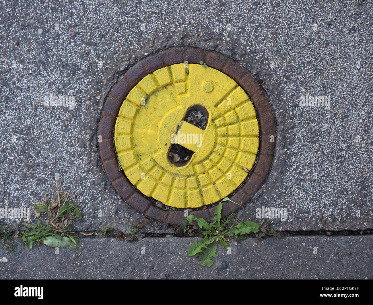 detail of a yellow manhole in the street Stock Photo - Alamy